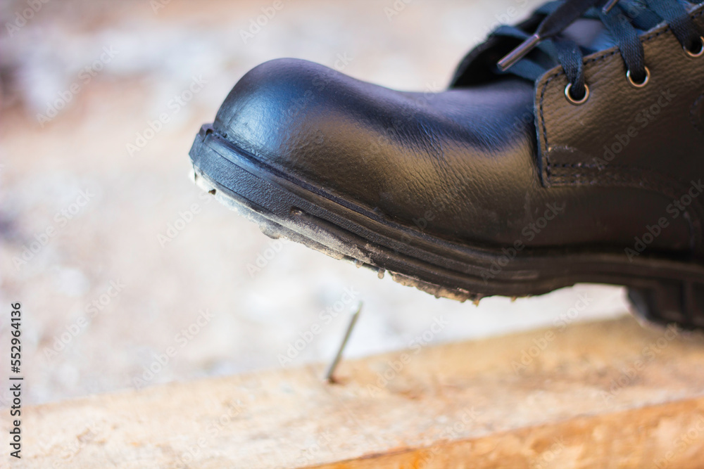 Wear safety shoes to ensure safety at work. construction workers wear ...
