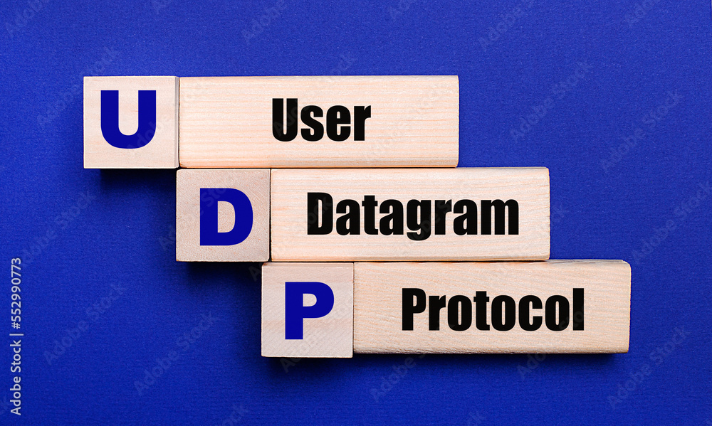 On a bright blue background, light wooden blocks and cubes with the ...