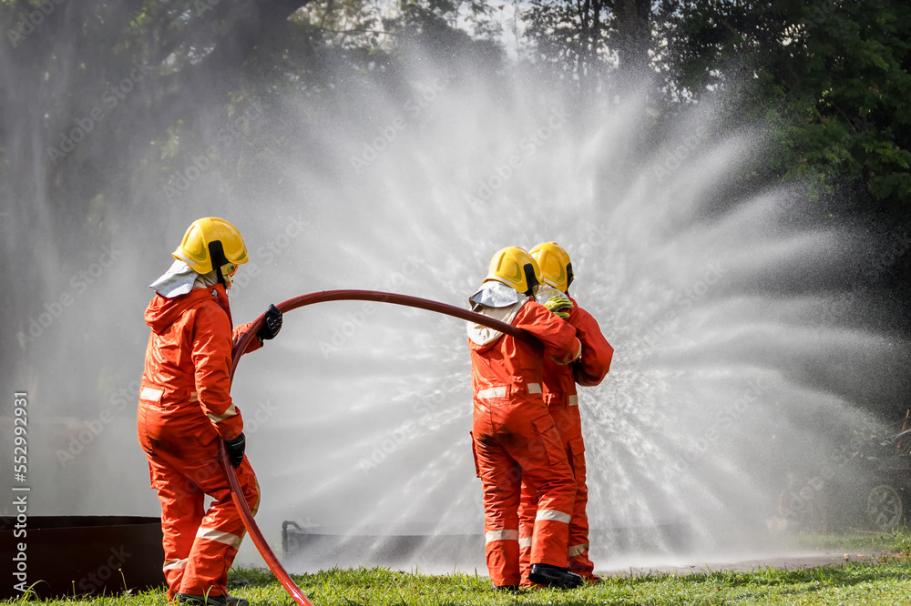 Firefighter Concept. Fireman using water and extinguisher to fighting ...