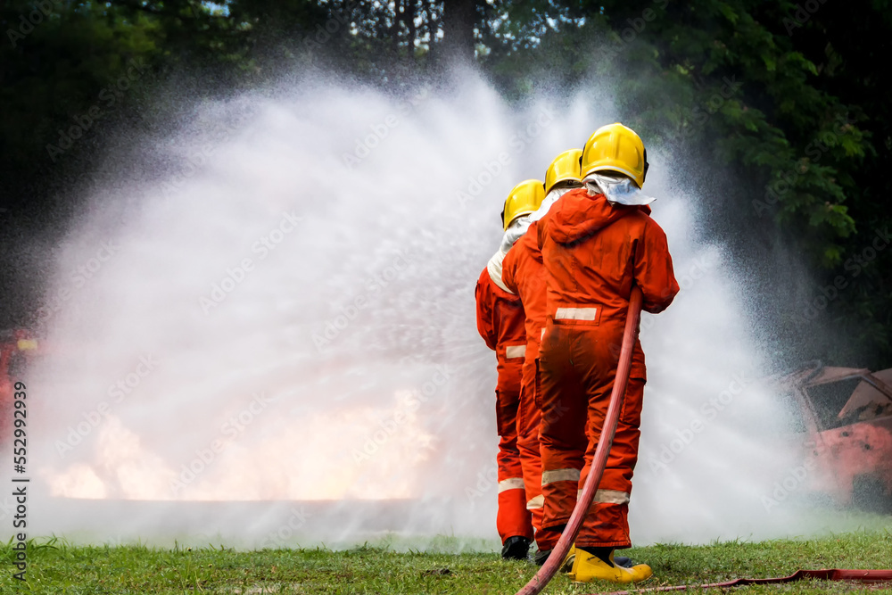 Firefighter Concept. Fireman using water and extinguisher to fighting ...
