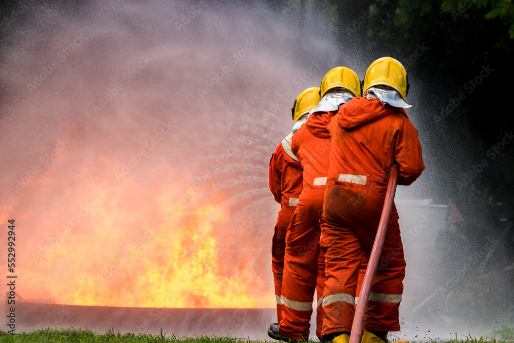 Firefighter Concept. Fireman using water and extinguisher to fighting ...