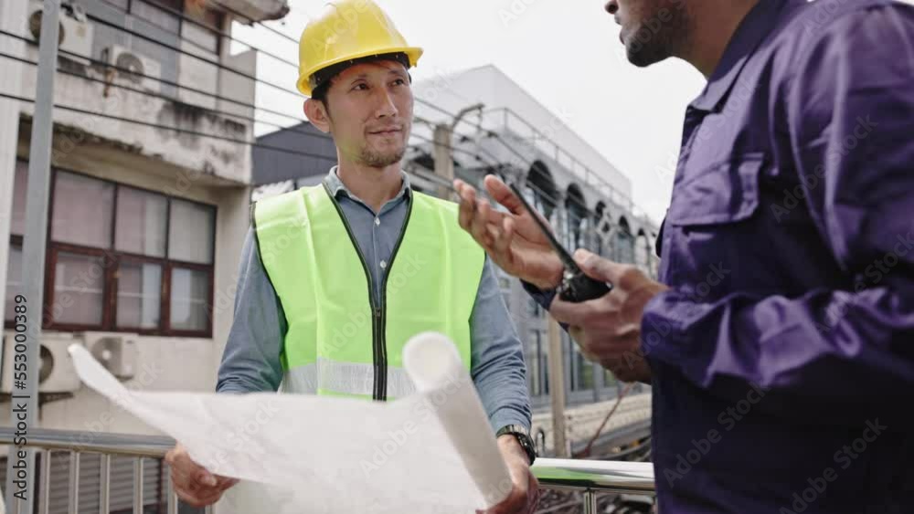 Structural engineers and construction workers are holding blueprints ...