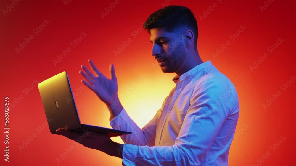 Computer problem. Angry man. Neon light portrait. Displeased guy being ...