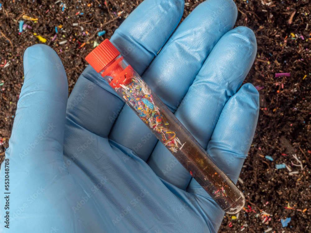 Microplastics in soil a test tube with soil sample - soil contaminated ...