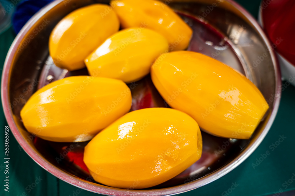 Mango, a photo of fresh yellow mango pile on market table. Ripe ...