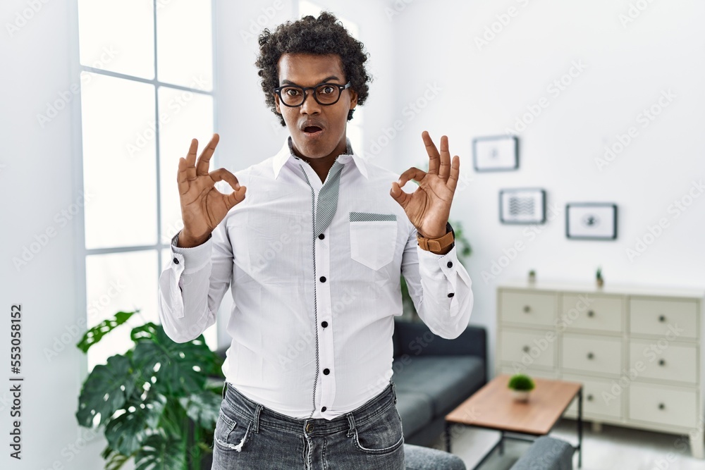 African psychologist man at consultation office looking surprised and ...