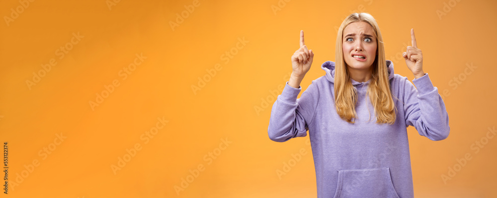 Worried perplexed unsure cute blond woman presenting project standing ...
