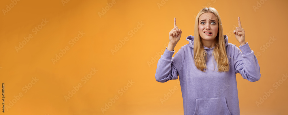 Worried perplexed unsure cute blond woman presenting project standing ...