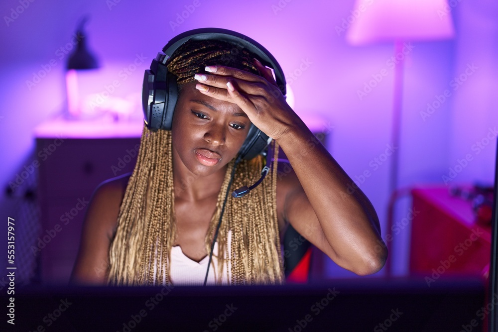 African american woman streamer stressed using computer at gaming room ...
