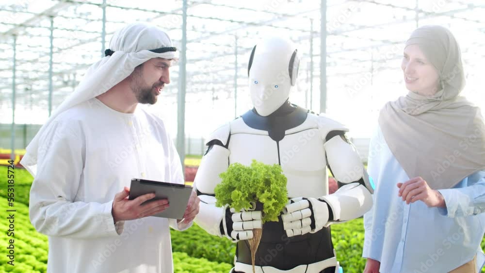 Portrait of modern scientific robot standing holding plants with muslim ...