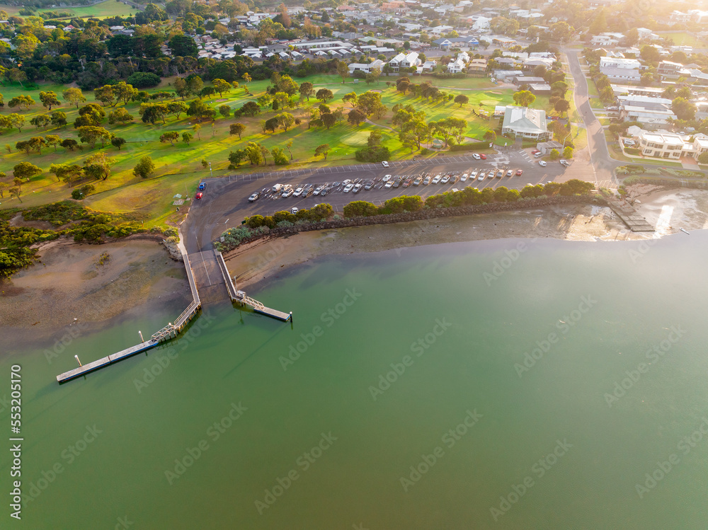 Aerial view of a boat ramp and carpark near a golf course on the bank ...