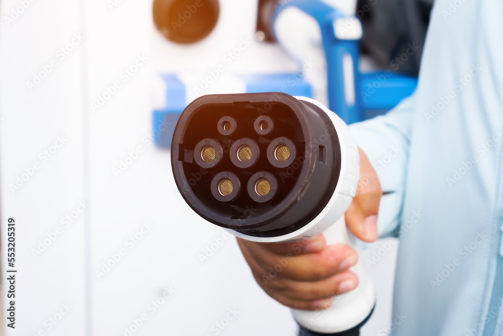 Hand holding Charge EV battery point for electric connector engine Plug ...