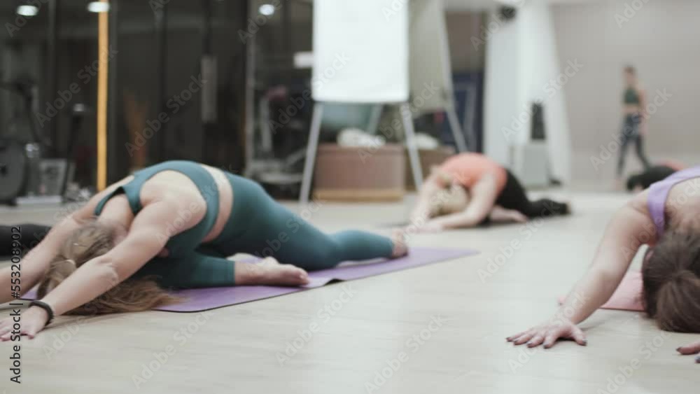 Yoga instructor having class with students. Girls practicing yoga ...