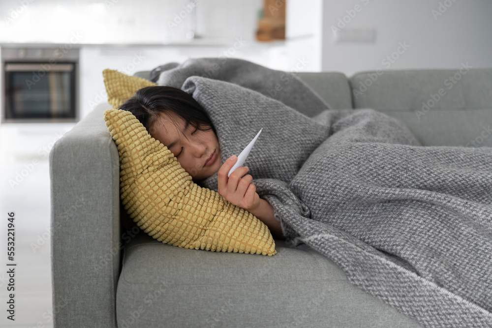 Winter Illnesses. Young sick unhealthy Asian woman suffering from fever ...