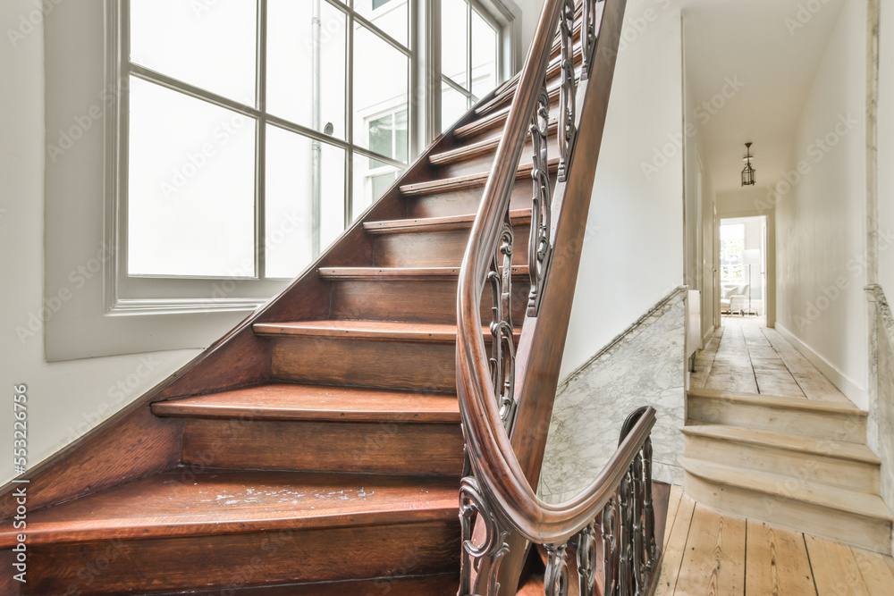 Hallway with wooden stairway leading to second floor of modern luxury ...