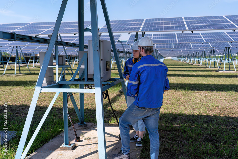 Maintenance engineer at solar farm trouble shooting looking at inverter ...