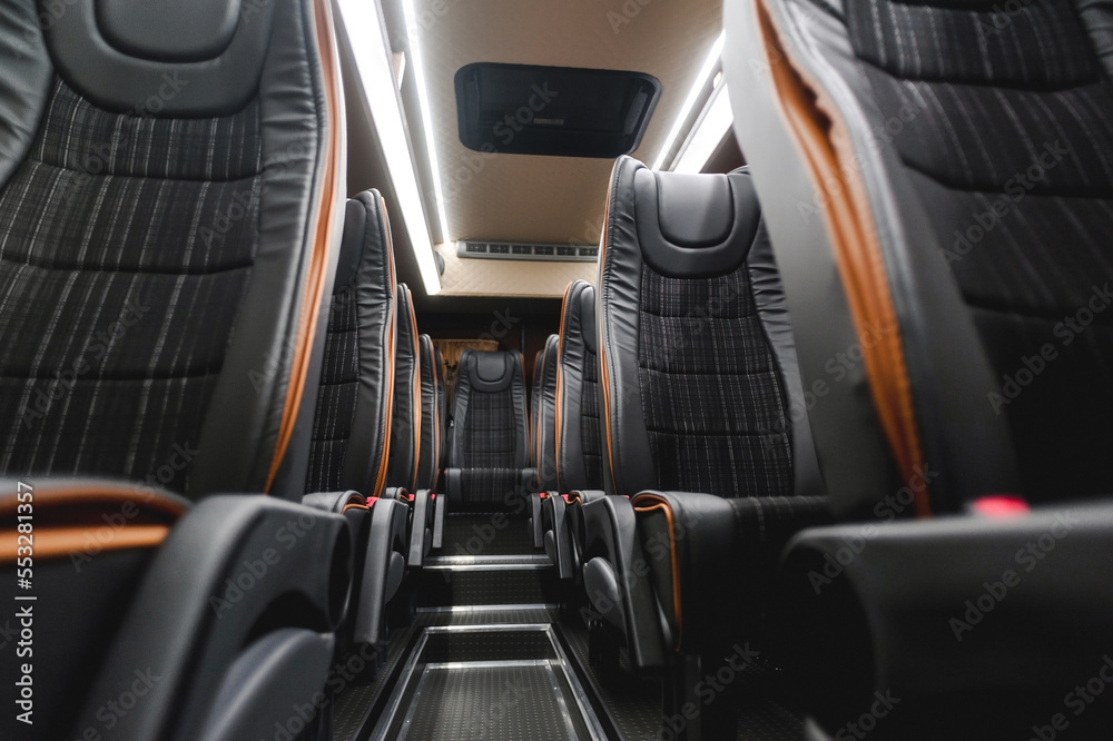 comfortable passenger bus interior with upholstered seats; individual ...