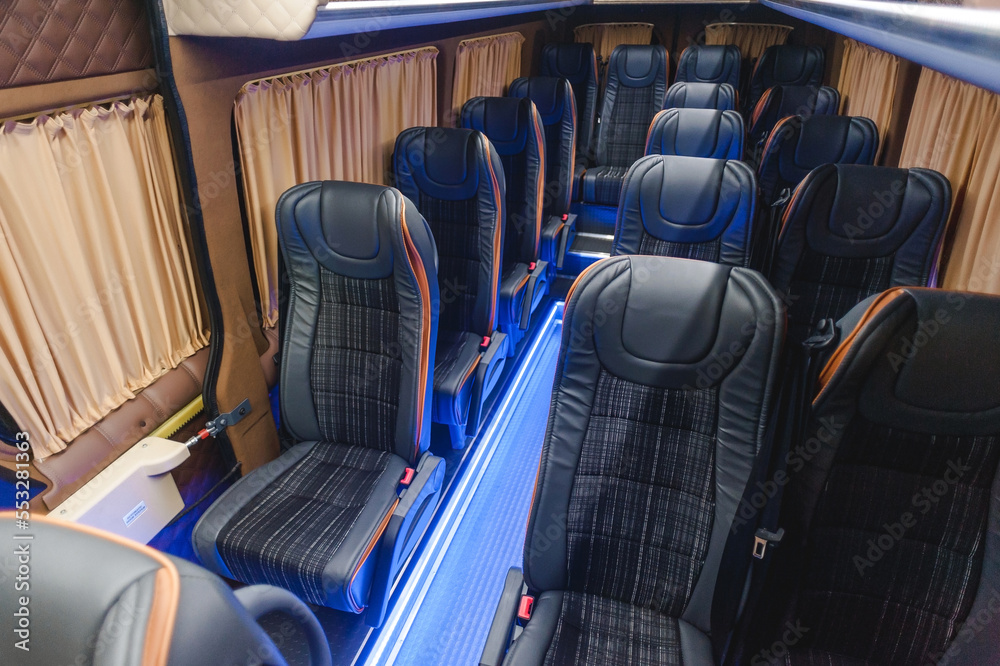 comfortable passenger bus interior with upholstered seats; individual ...