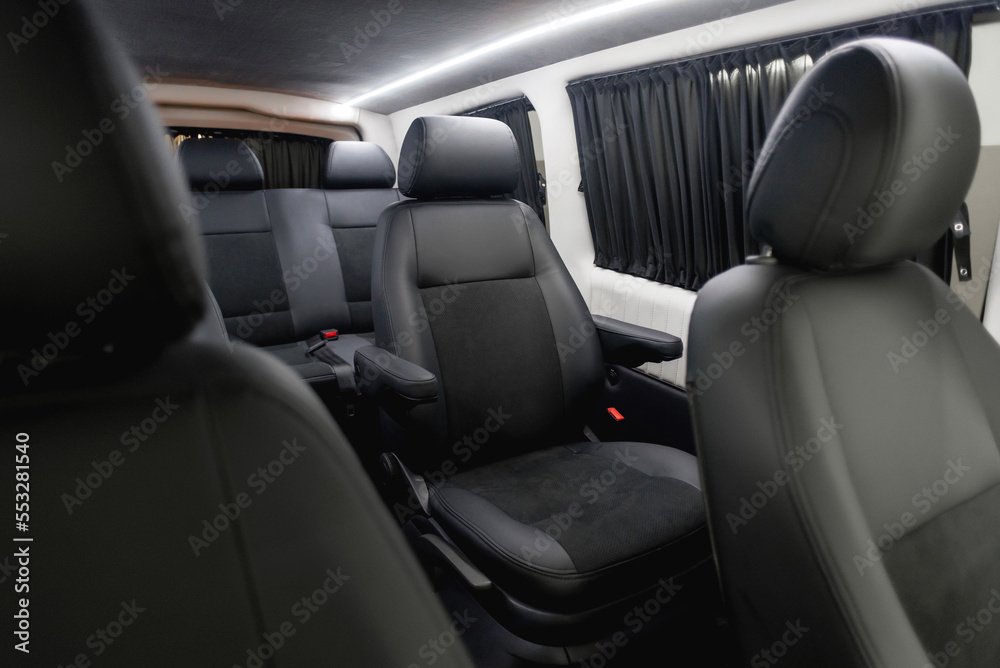 comfortable passenger bus interior with upholstered seats; individual ...