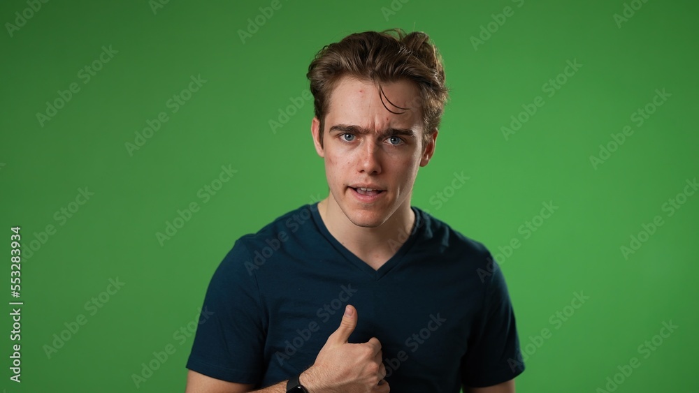 Confused young man 20s posing isolated on green screen background in ...
