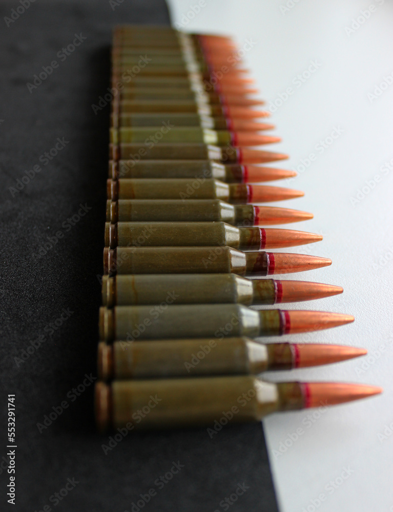 Vertical Photo Of Unitary Cartridges For Assault Rifle In Line On Black ...