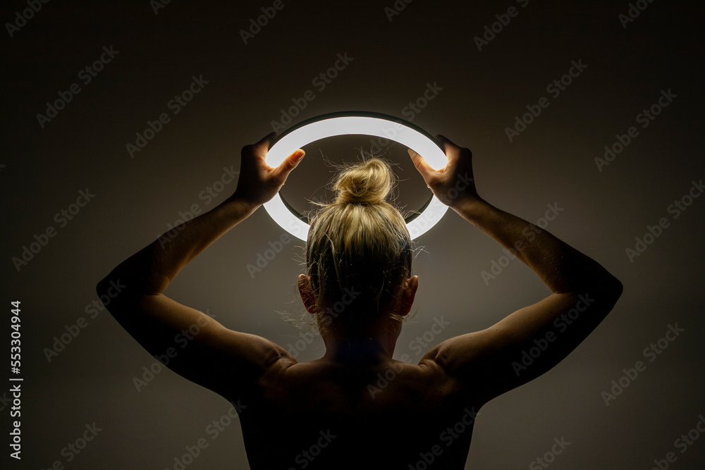 Blonde woman without clothes, only with a light ring showing her ...