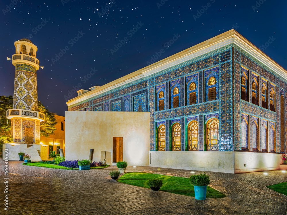 Village mosque illuminated with stars in the sky at night in katara ...