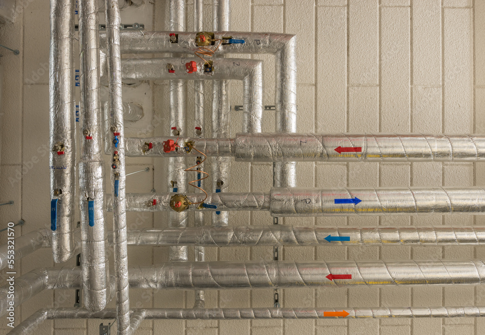 Multiple insulated heating and water pipes, internal building ...