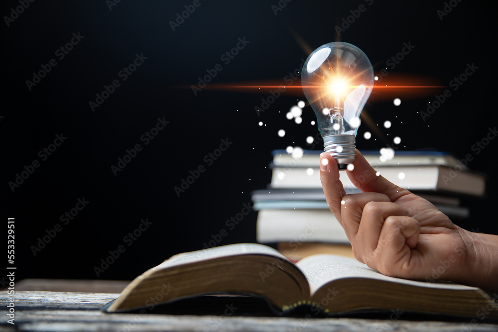 Light bulbs and books. Concept of reading books, knowledge, and ...