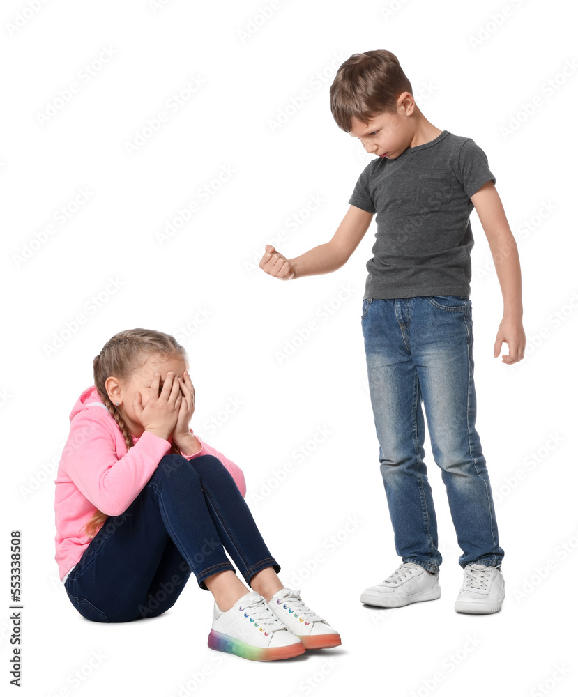 Boy with clenched fist looking at scared girl on white background ...