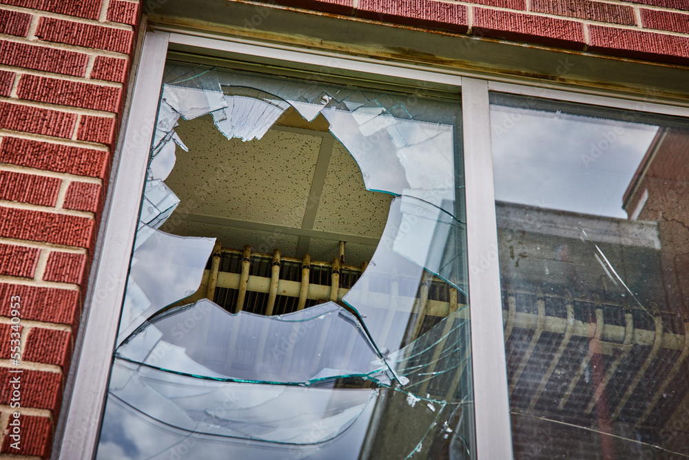 Broken glass window detail with multiple layers on brick building Stock ...