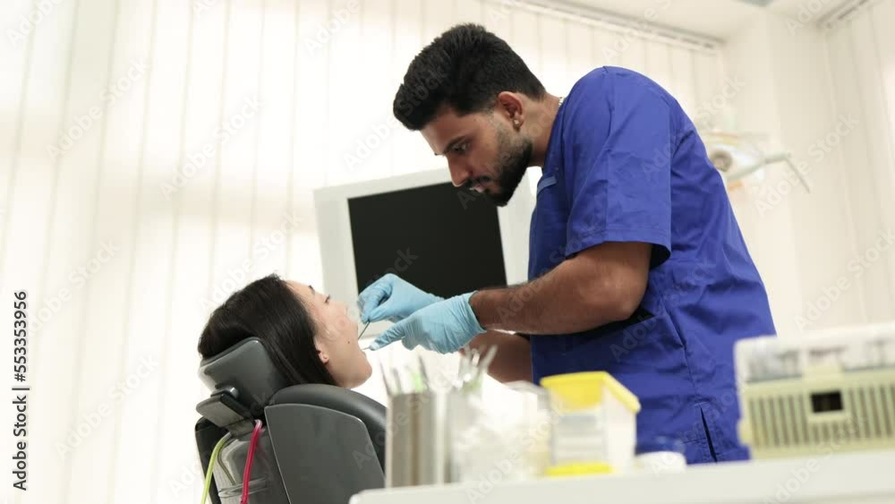 Side view of bearded male doctor in white uniform and gloves, making ...