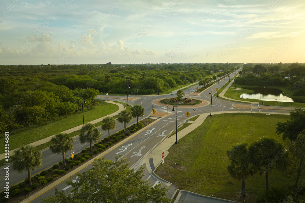 Aerial view of road roundabout intersection with moving cars traffic ...