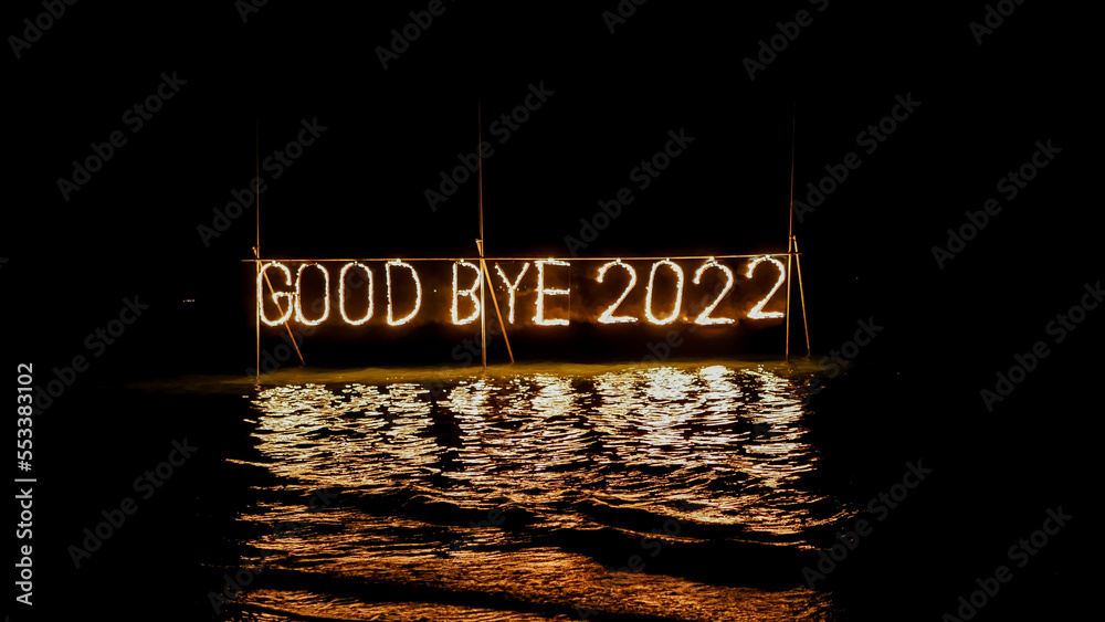 good bye 2022 burning phrase made of fire stick placed on water in sea ...