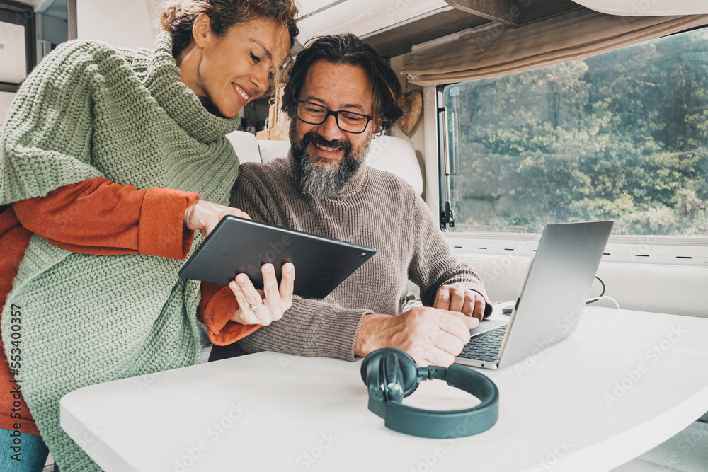 Modern couple of traveler enjoy work office inside camper van. Happy ...