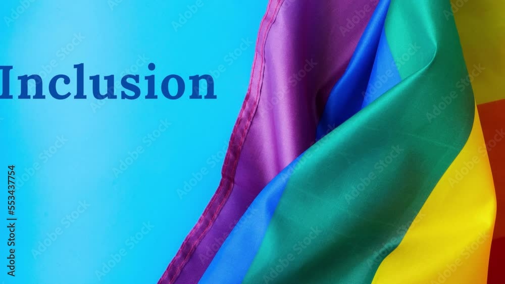 4k zoom in out Rainbow flag with text INCLUSION message. Rainbow lgbtq ...