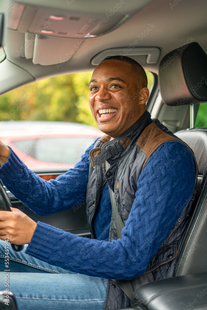 Laughing man driving car Stock Photo | Adobe Stock