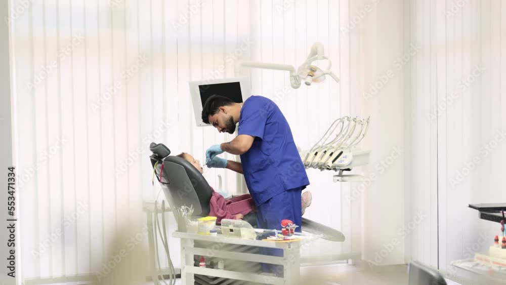 Side view of smiling male professional doctor in blue uniform and ...