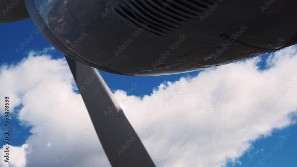Shot from bottom of back, gray propeller with yellow stripes at ends of ...