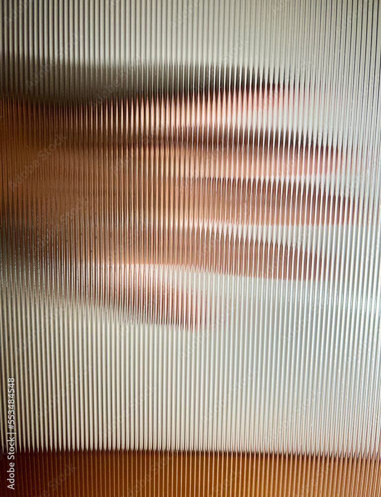 View of left hand with lighting behind through vertical lines of ...