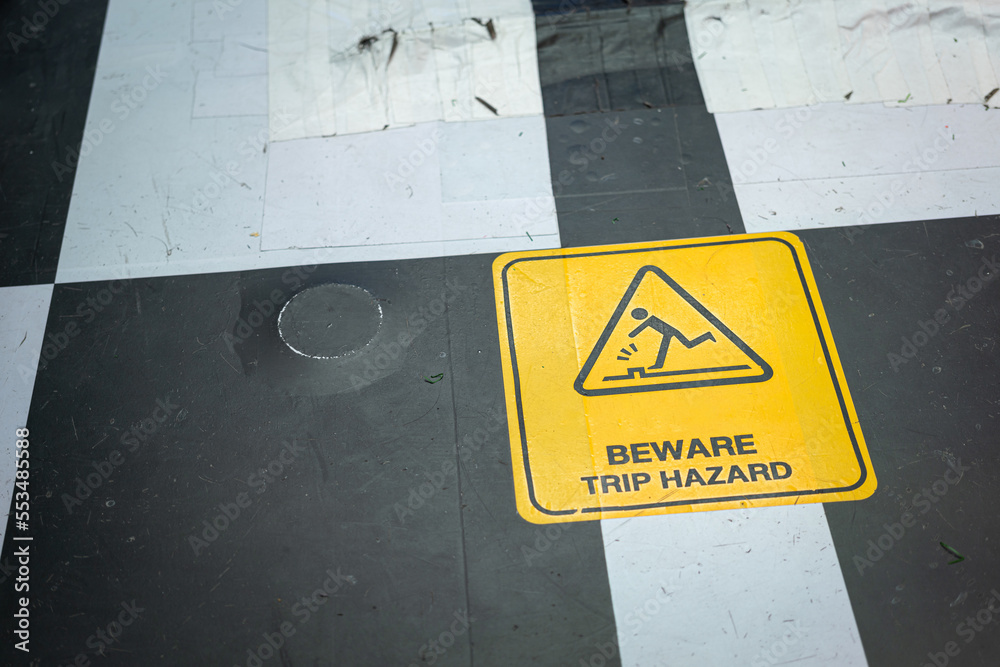 "Beware trip hazard" safety caution symbol on the ground. Sign and ...