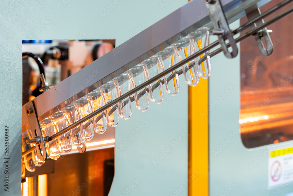 transparent preform plastic pet during transport by inclined hanging ...