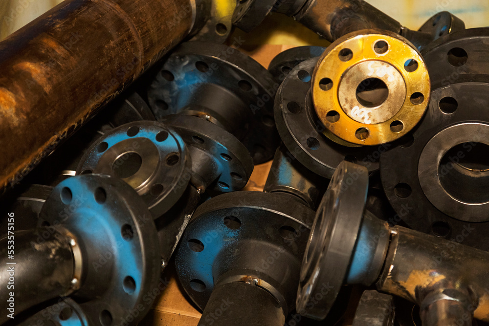 Flanges tack welded to pipes ready to butt weld in a fabrication plant ...