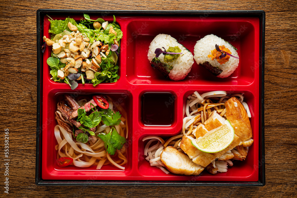 bento with dumplings and salad in the traditional Japanese ramen ...