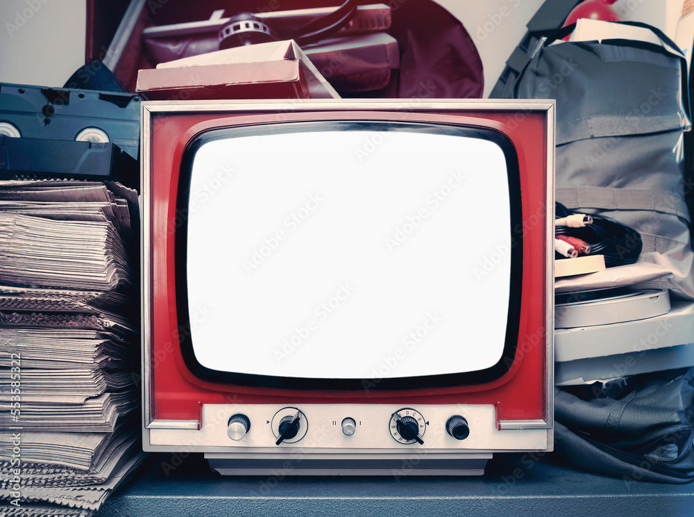 An old CRT TV set inside a bright storage room, with VHS tapes and ...