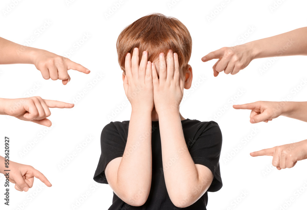 Boy covering face with hands and kids pointing at him on white ...
