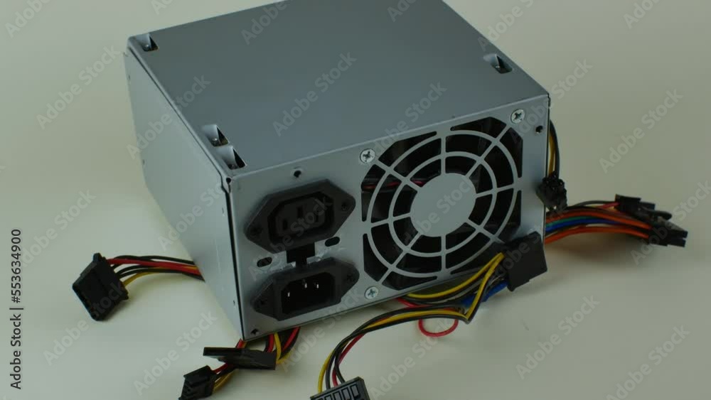 Close-up of a computer power supply on a light background with multi ...