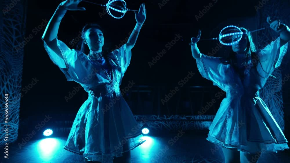 Light LED dance show. Impressive dances of two beautiful girls in ...