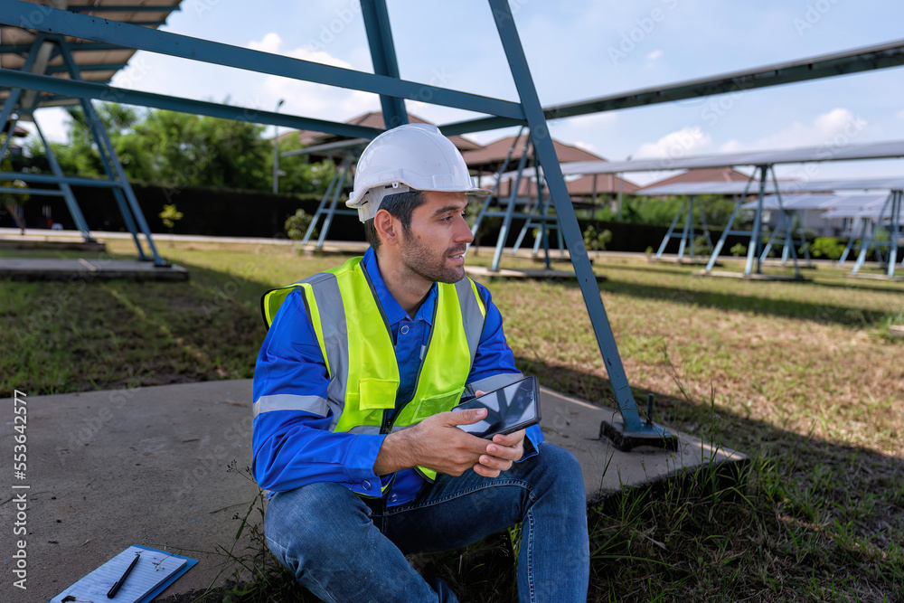 Engineer at solar farm on break time sitting look social media from ...