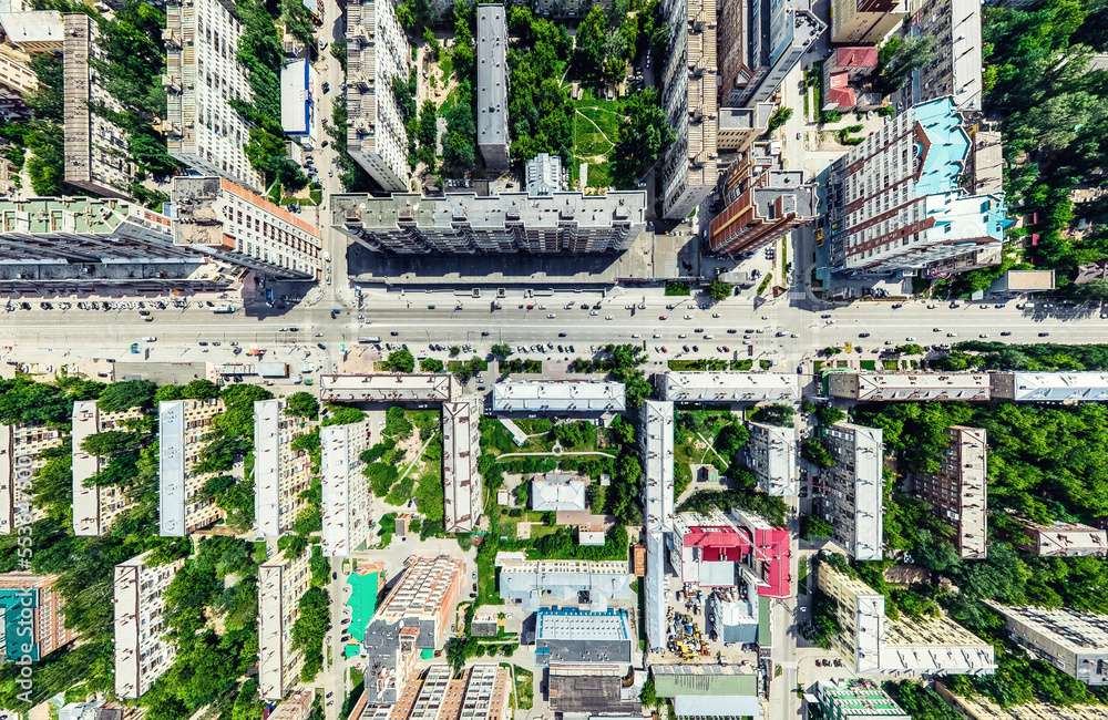 Aerial city view with crossroads and roads, houses, buildings, parks ...